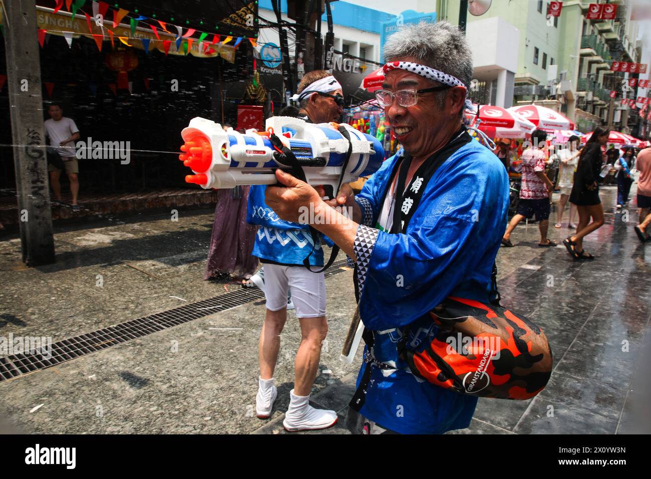 A tourist plays with a water gun during the Songkran holiday ...