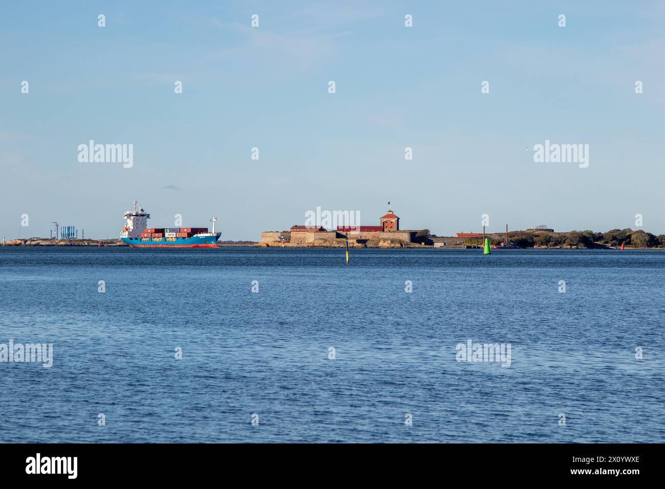 Container ship is entering port inlet of Gothenburg, Sweden. A medieval ...