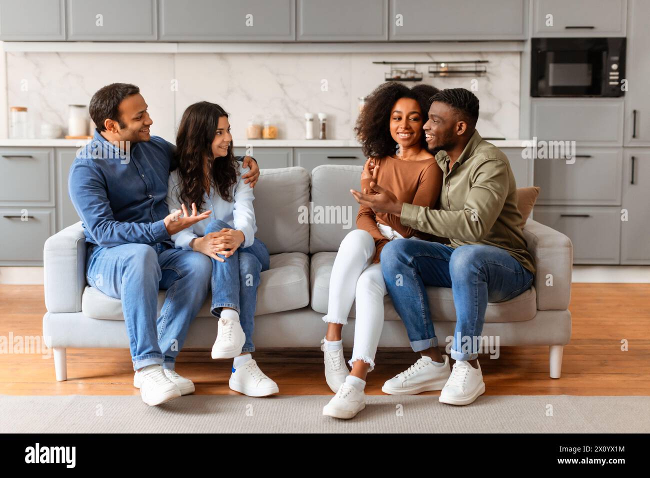 Multicultural couples sitting on hi-res stock photography and images ...