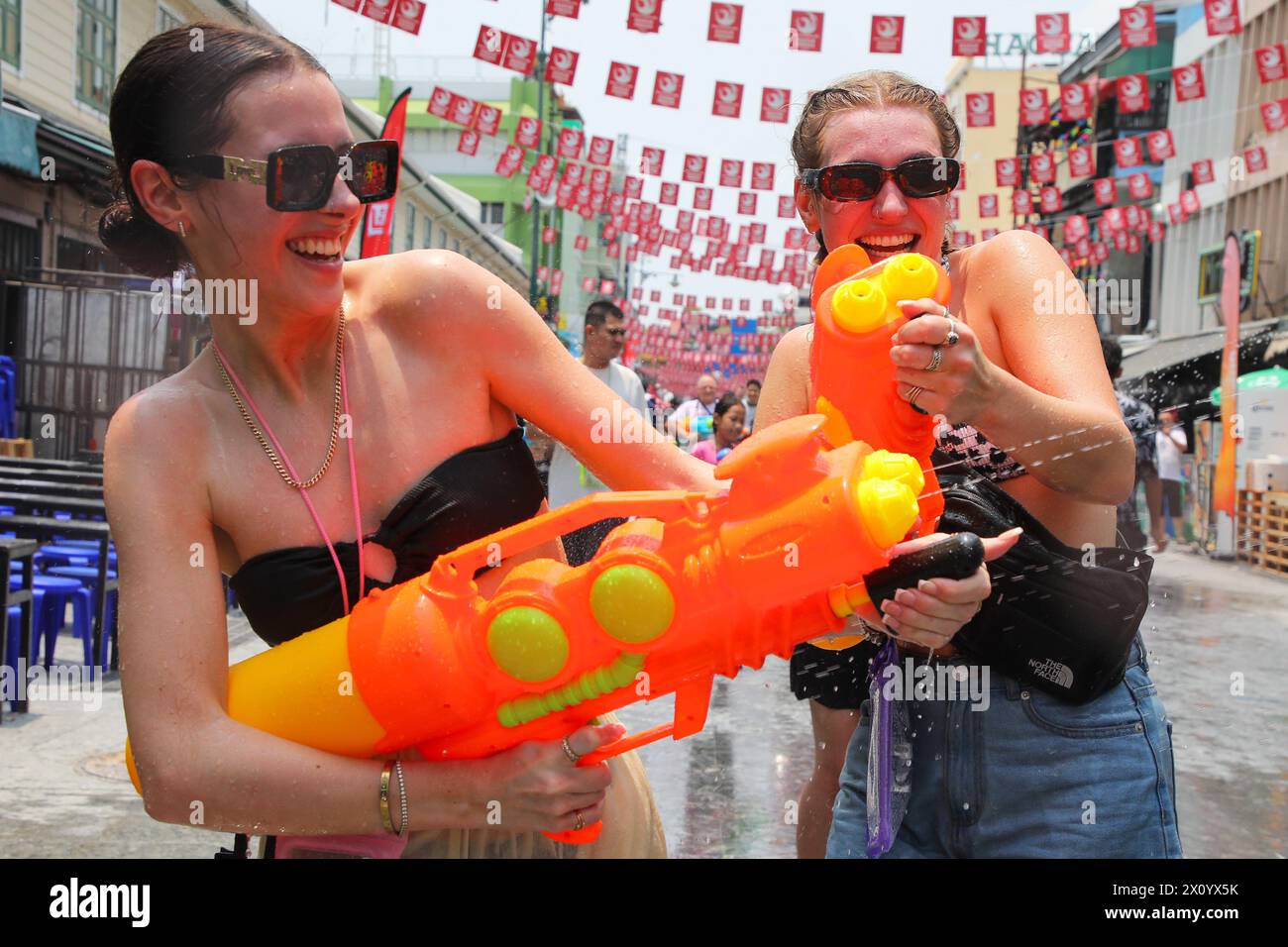 Bangkok, Thailand. 14th Apr, 2024. Tourists play with water guns during the Songkran holiday ...