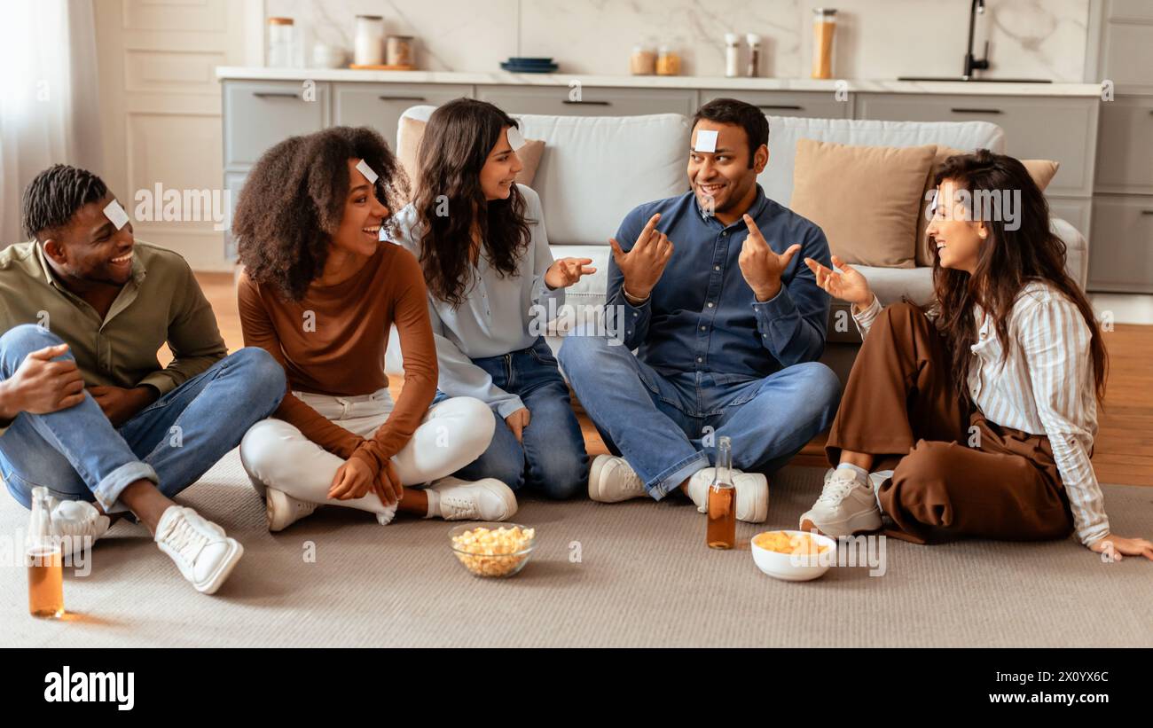 Multiracial group playing guess who hi-res stock photography and images ...