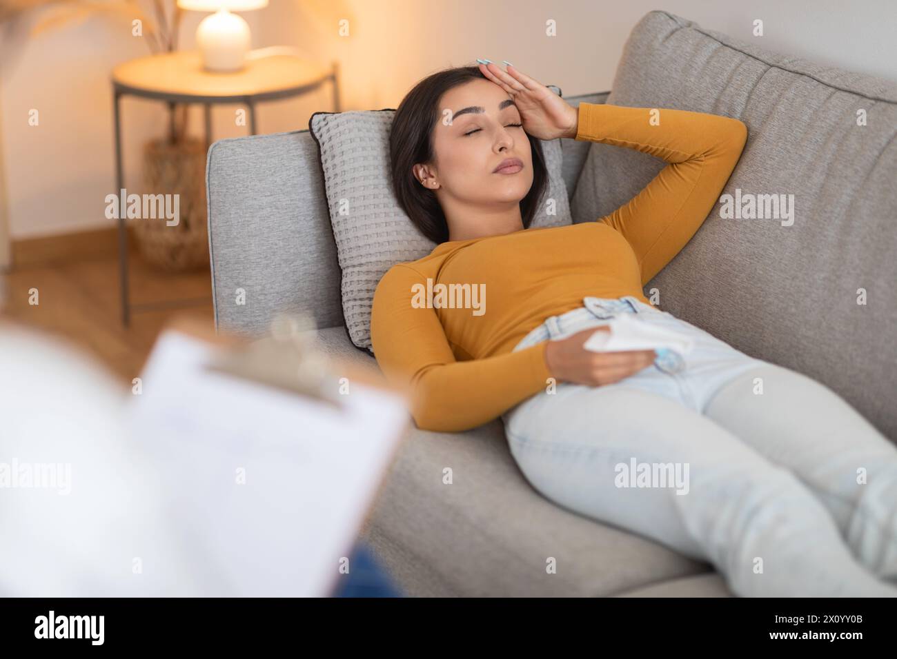 Woman with eyes closed during a therapy visit Stock Photo - Alamy