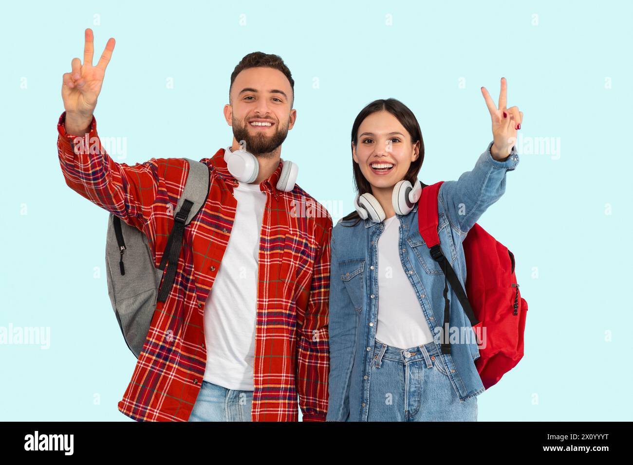 Smiling young duo posing with peace signs Stock Photo - Alamy
