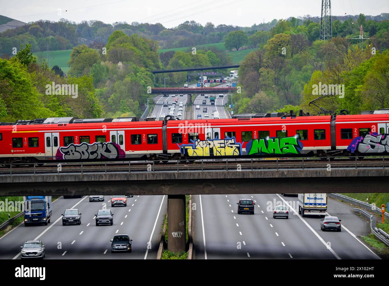 S-Bahn Zug überquert die Autobahn A3, Verkehr auf 8 Spuren, inkl. des ...