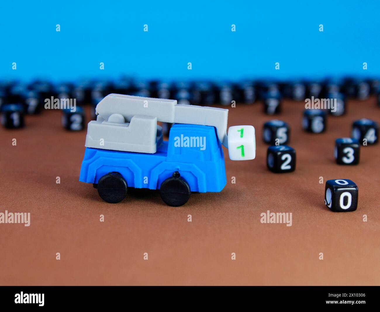 Crane lifting up cube with number that differs by color from the rest ...