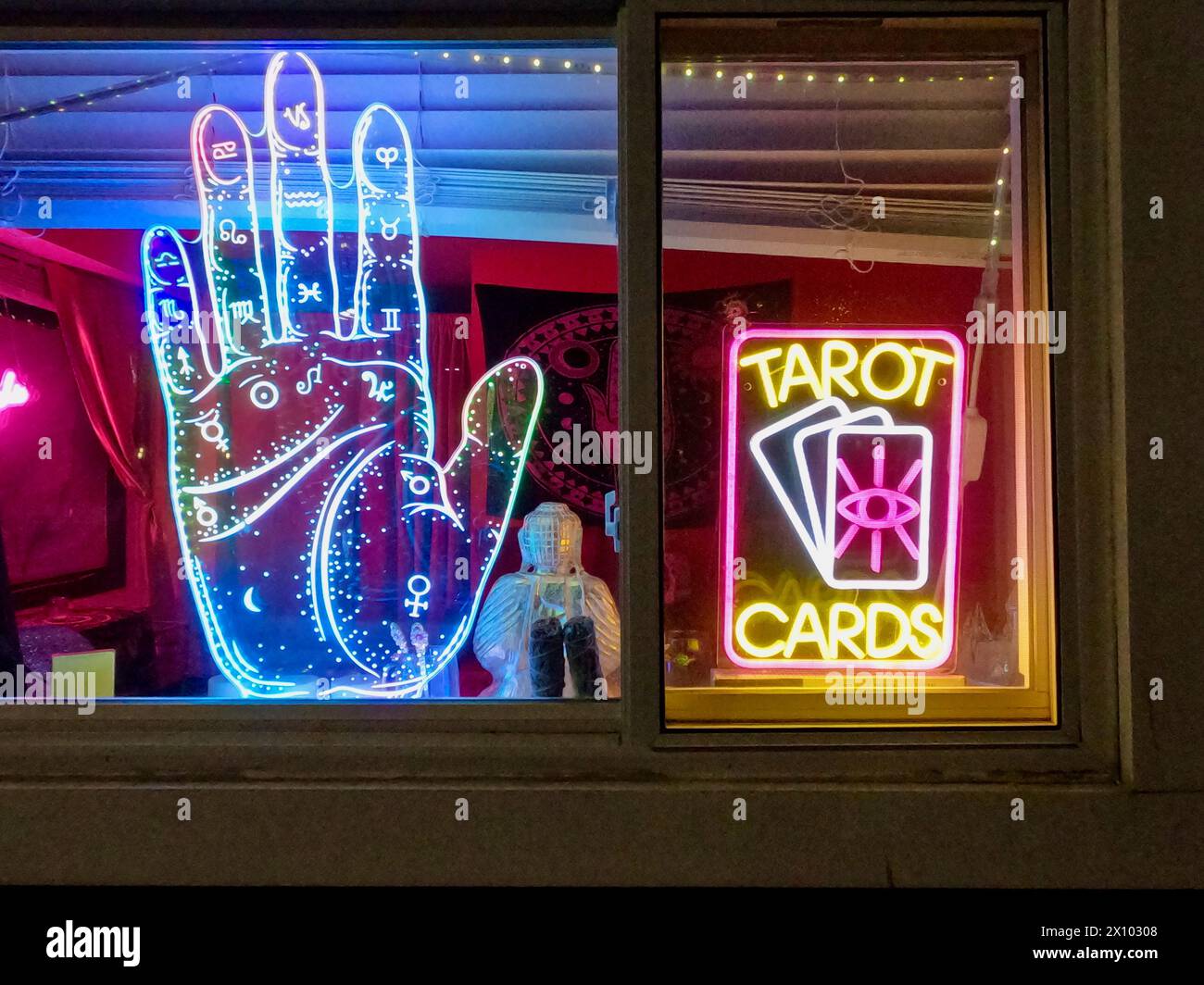 Neon signs glow in the window of a psychic's shop in Philadelphia's ...