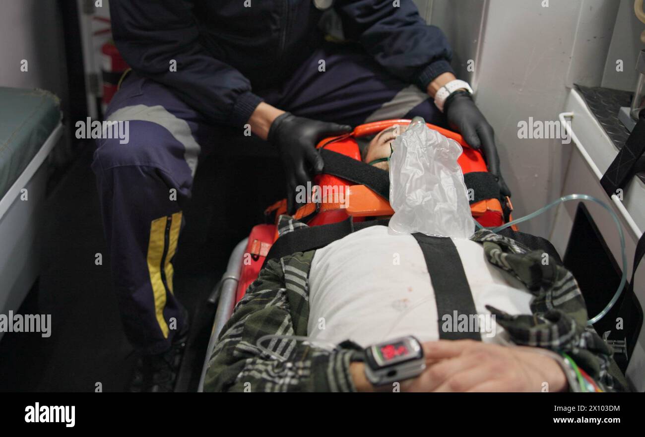 Patient, paramedic and man with oxygen mask in ambulance for emergency ...