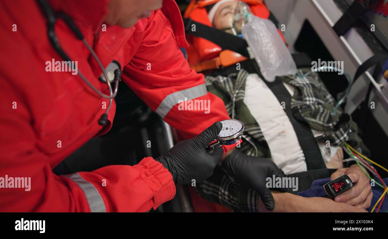 Watch, pulse and hands of a paramedic with a patient in an ambulance ...