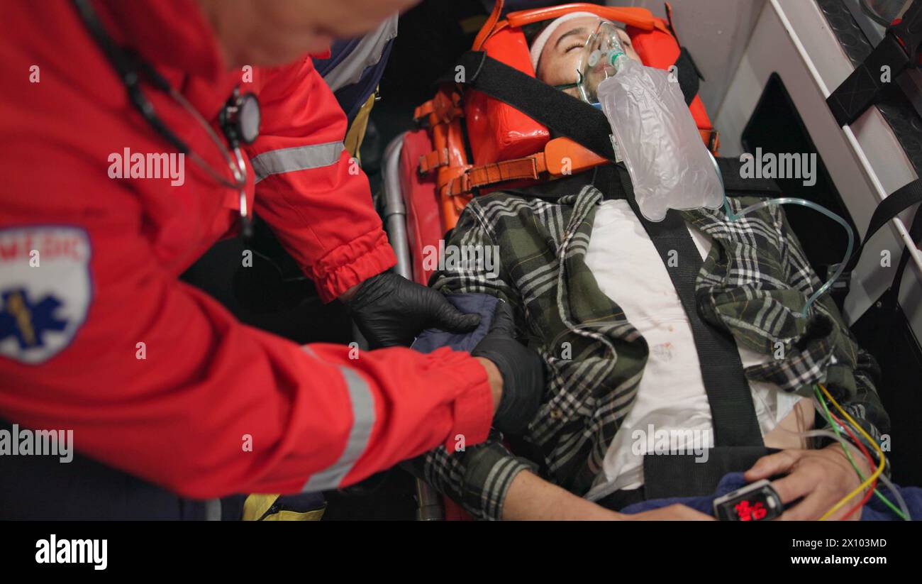 Patient, paramedic and blood pressure with oxygen mask in ambulance for ...
