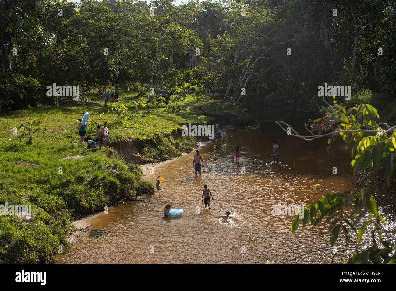 Locals swim in a popular swimming hole near Nauta in the Amazon ...
