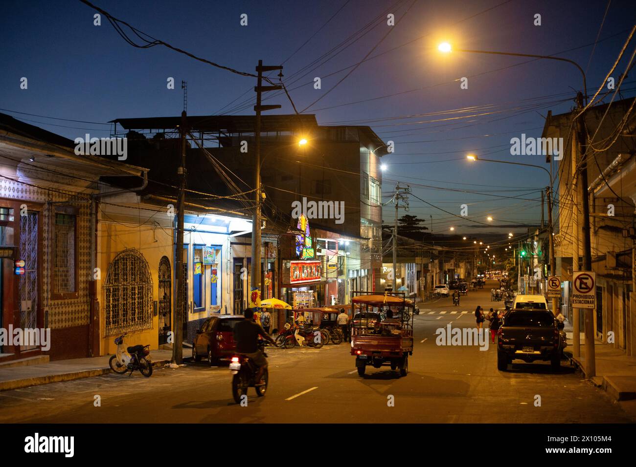 People wander the streets at dusk in the Plaza de Armas of Iquitos city ...