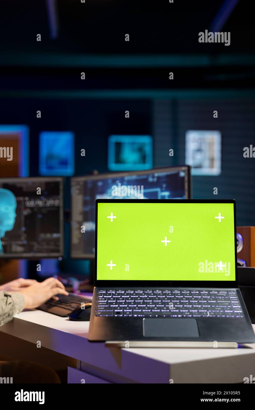 Focus on green screen laptop used by developer to update artificial intelligence machine ...