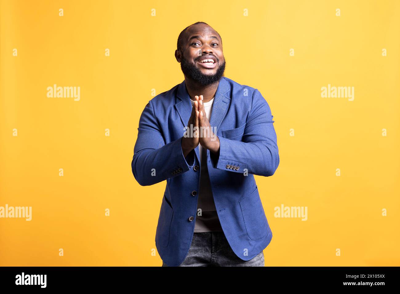 Cheerful african american man putting hands together in appreciation ...