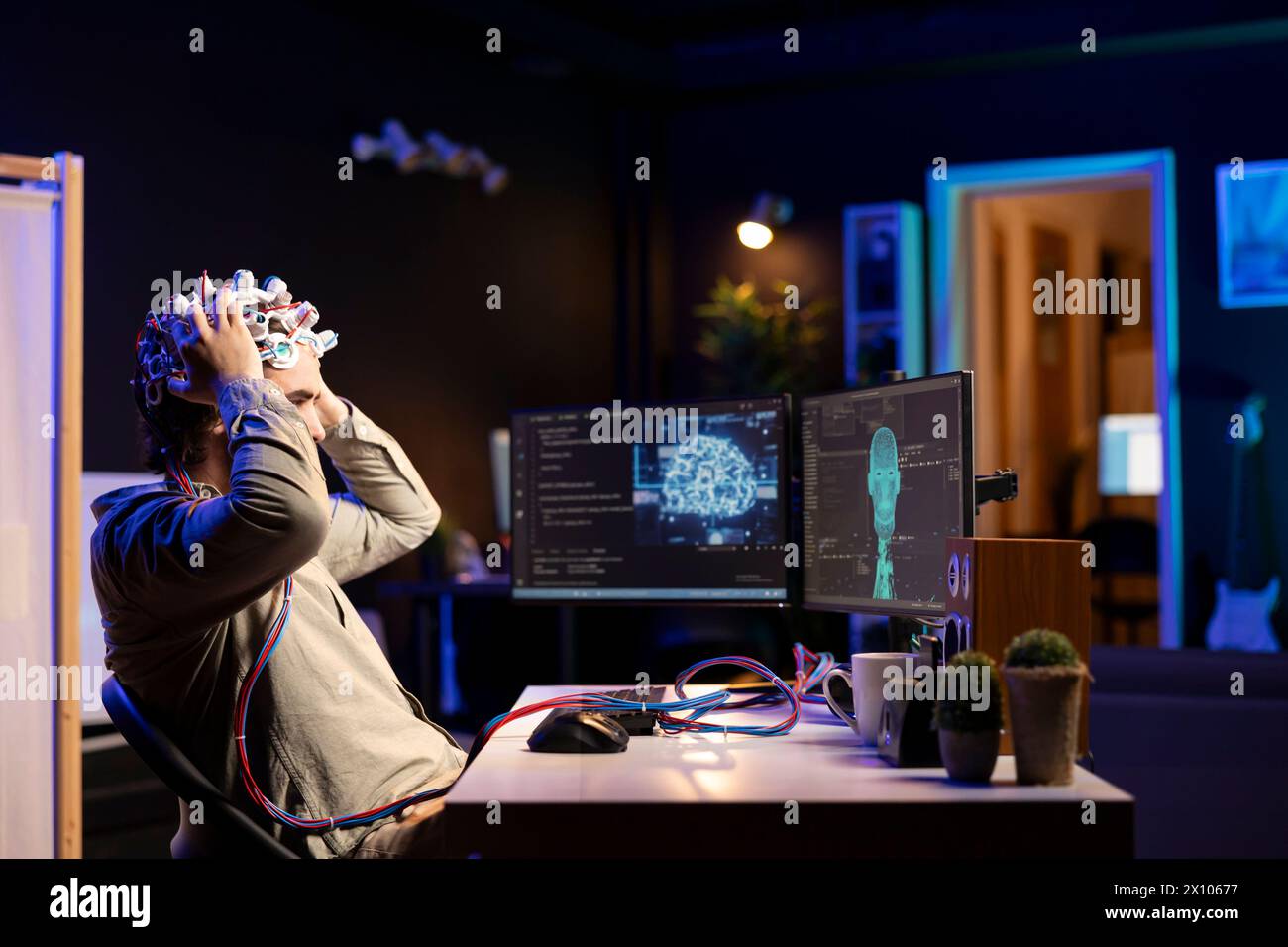 Software developer specializing in artificial intelligence putting EEG headset on to upload ...