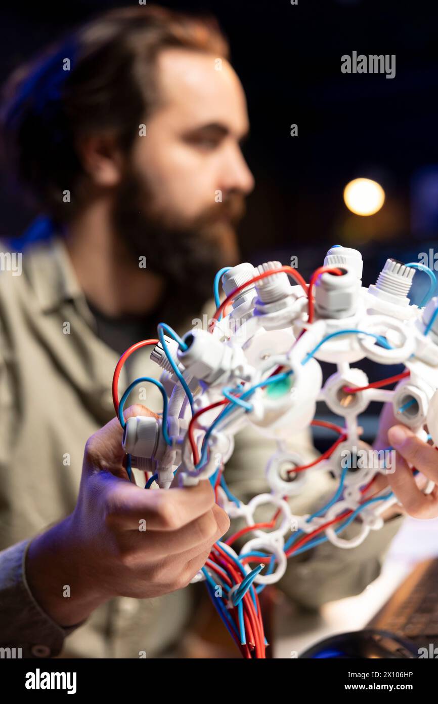 Focus on EEG headset used by IT professional in blurry background to ...