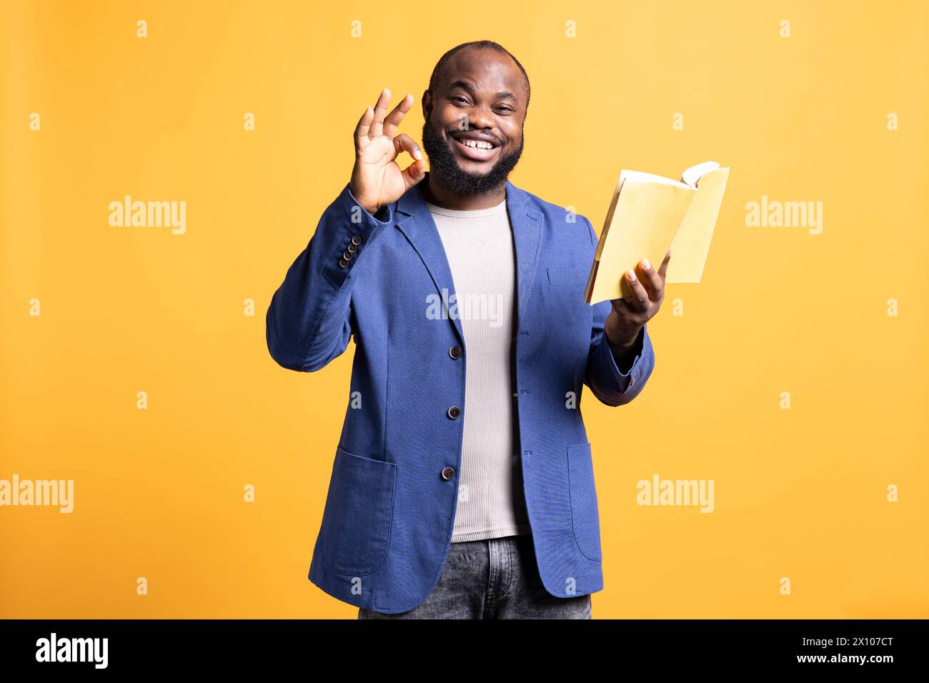 Portrait of smiling man recommending interesting book after being ...