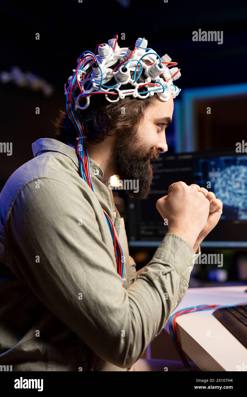 Smiling man with EEG headset on happy after transferring mind into ...
