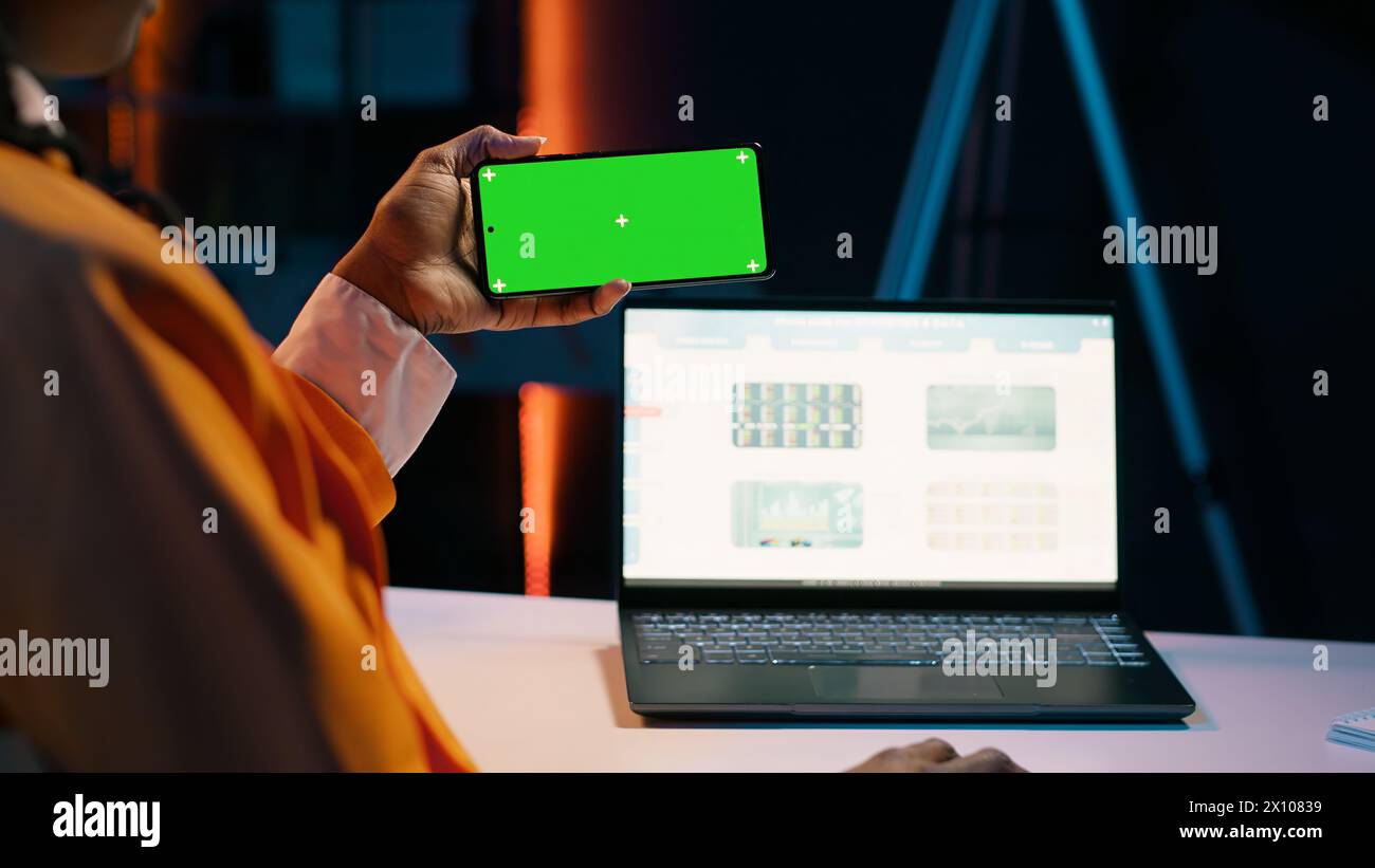 Business student looks at greenscreen on phone app and learning to use ...