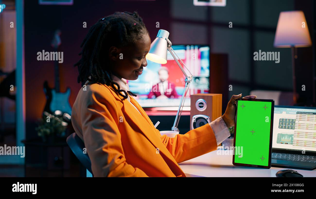 University student looking at greenscreen on tablet learning to use ...