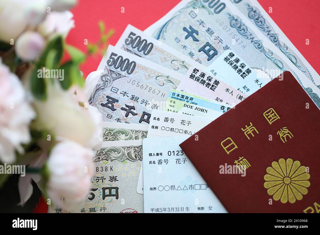 Light blue and red Japan Health Insurance cards on table with japanese ...