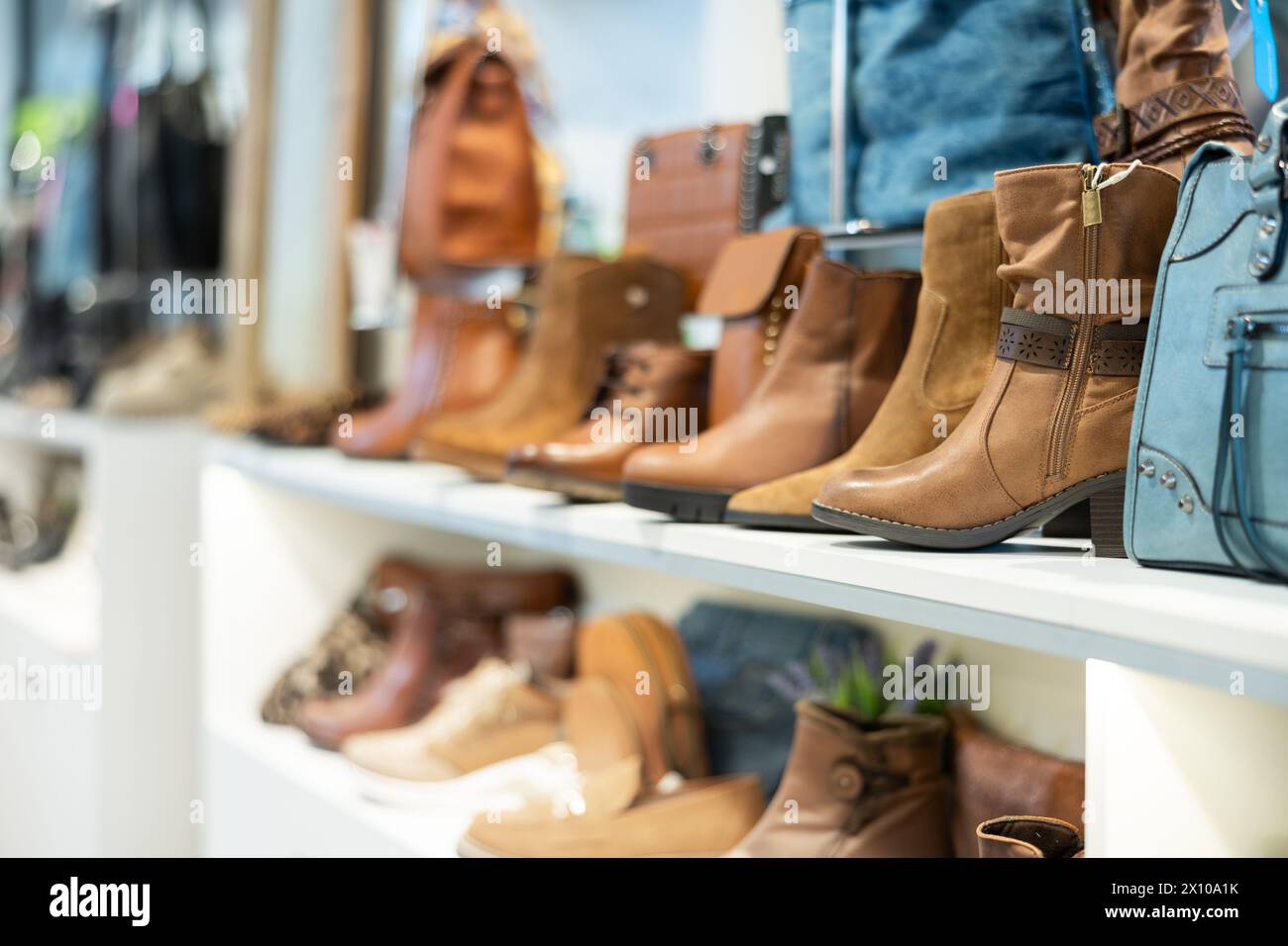Women's boots displayed on counter in store Stock Photo - Alamy
