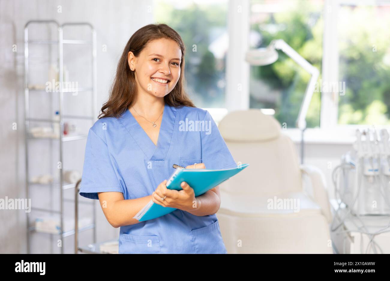 Young female doctor taking notes in medical room Stock Photo - Alamy