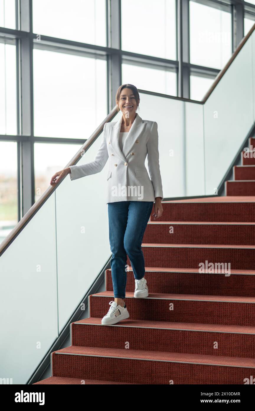 Pretty woman going down stairs hi-res stock photography and images - Alamy