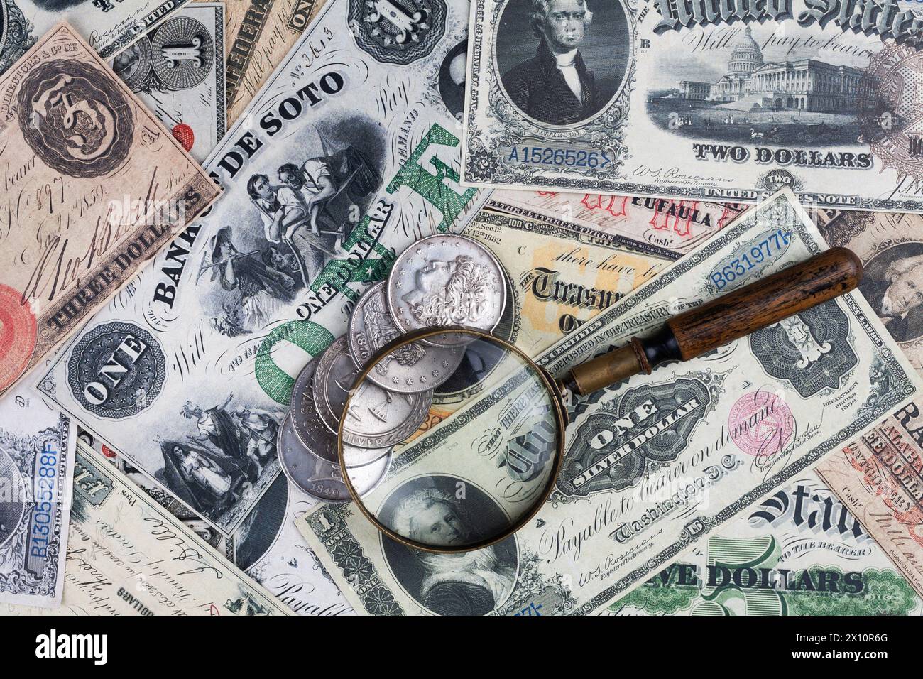 Old US banknotes and silver certificates with silver dollar coins and ...