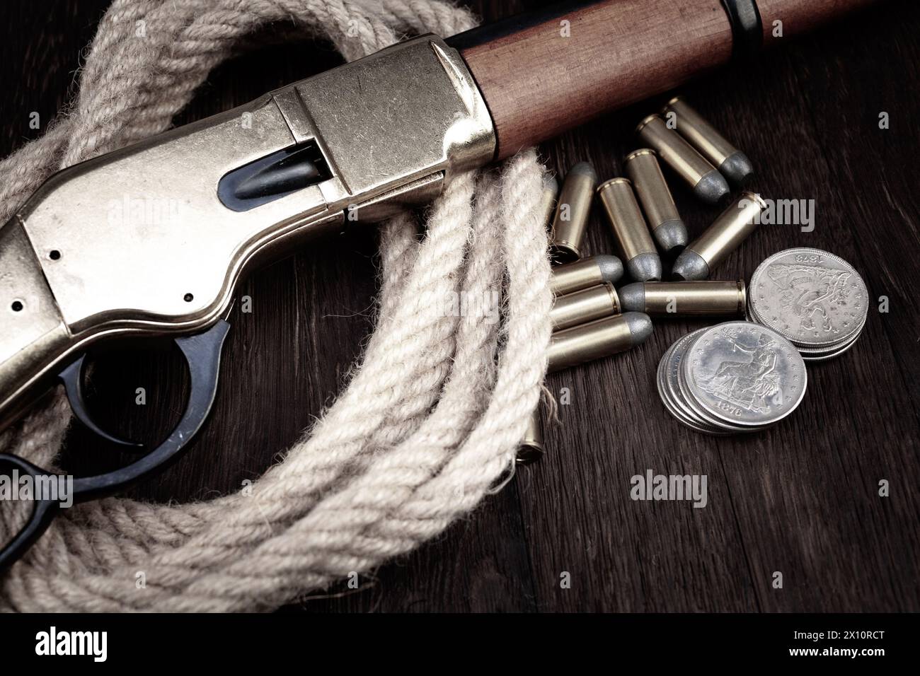 Old west lever action repeating rifle with ammunition and silver dollar ...