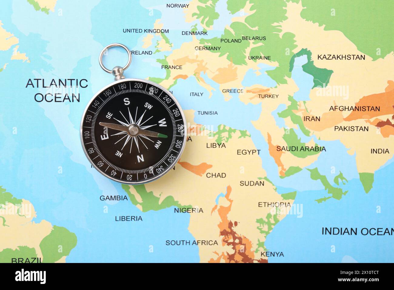 One compass on world map, top view. Space for text Stock Photo - Alamy