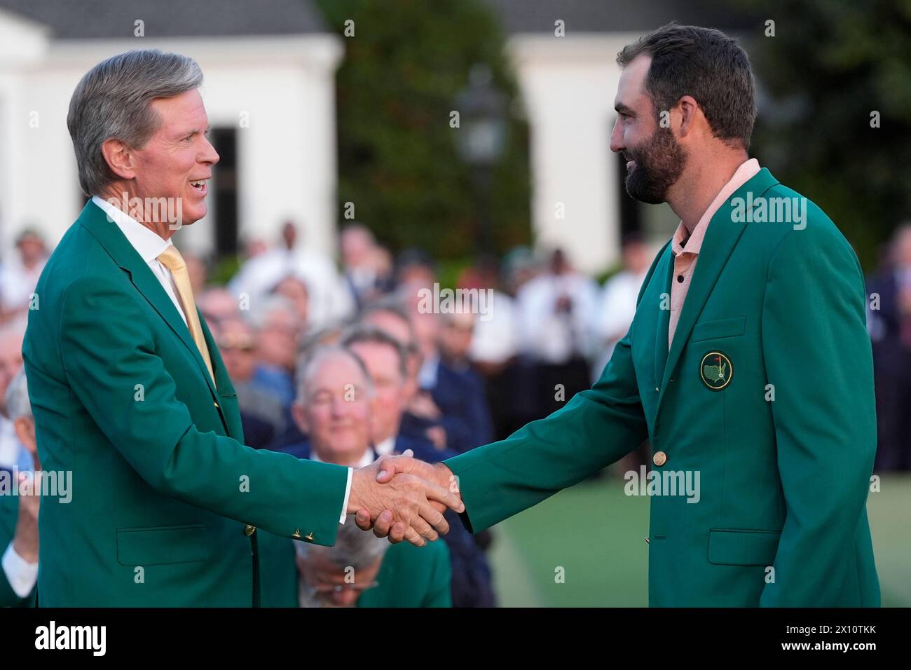 Fred Ridley, chairman of Augusta National Golf Club, shakes hands with ...