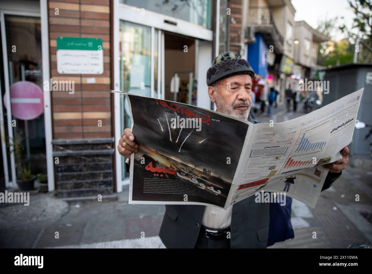 A man reads the last edition of the Iranian state daily, Jam-e-jam ...