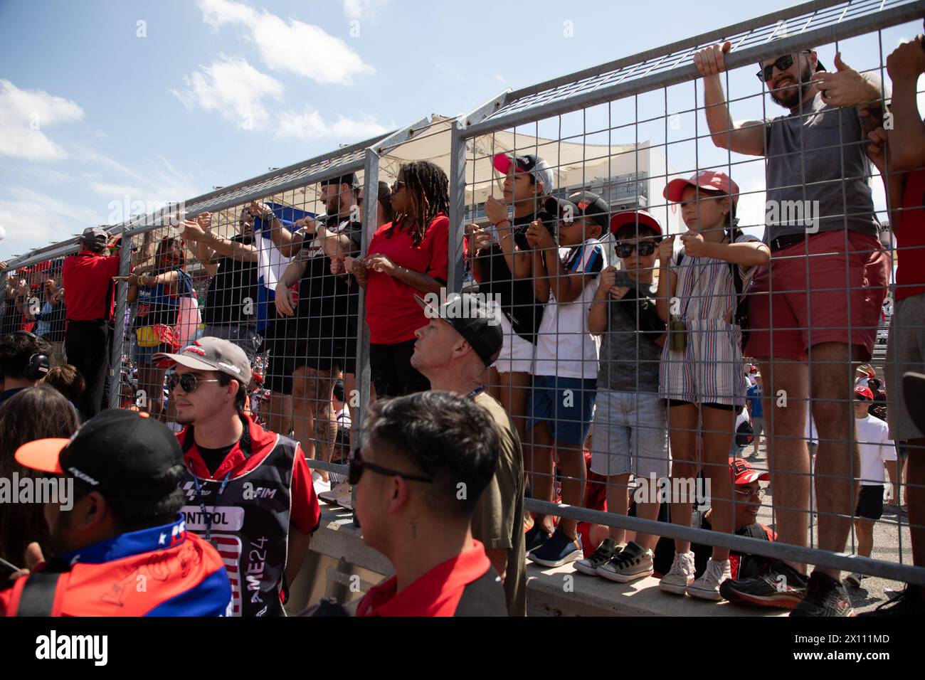 Austin, Usa . 14th Apr, 2024. Fans climb the fence ahead of the podium ...
