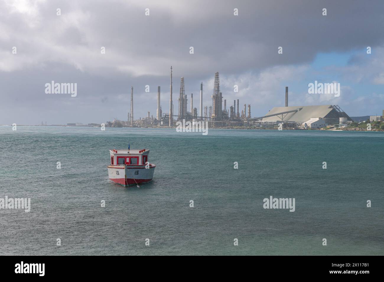 Lago Colony refinery and lagoon with boat in foreground Stock Photo - Alamy