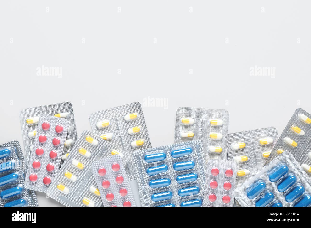 Different blister packs with pills on white background Stock Photo - Alamy