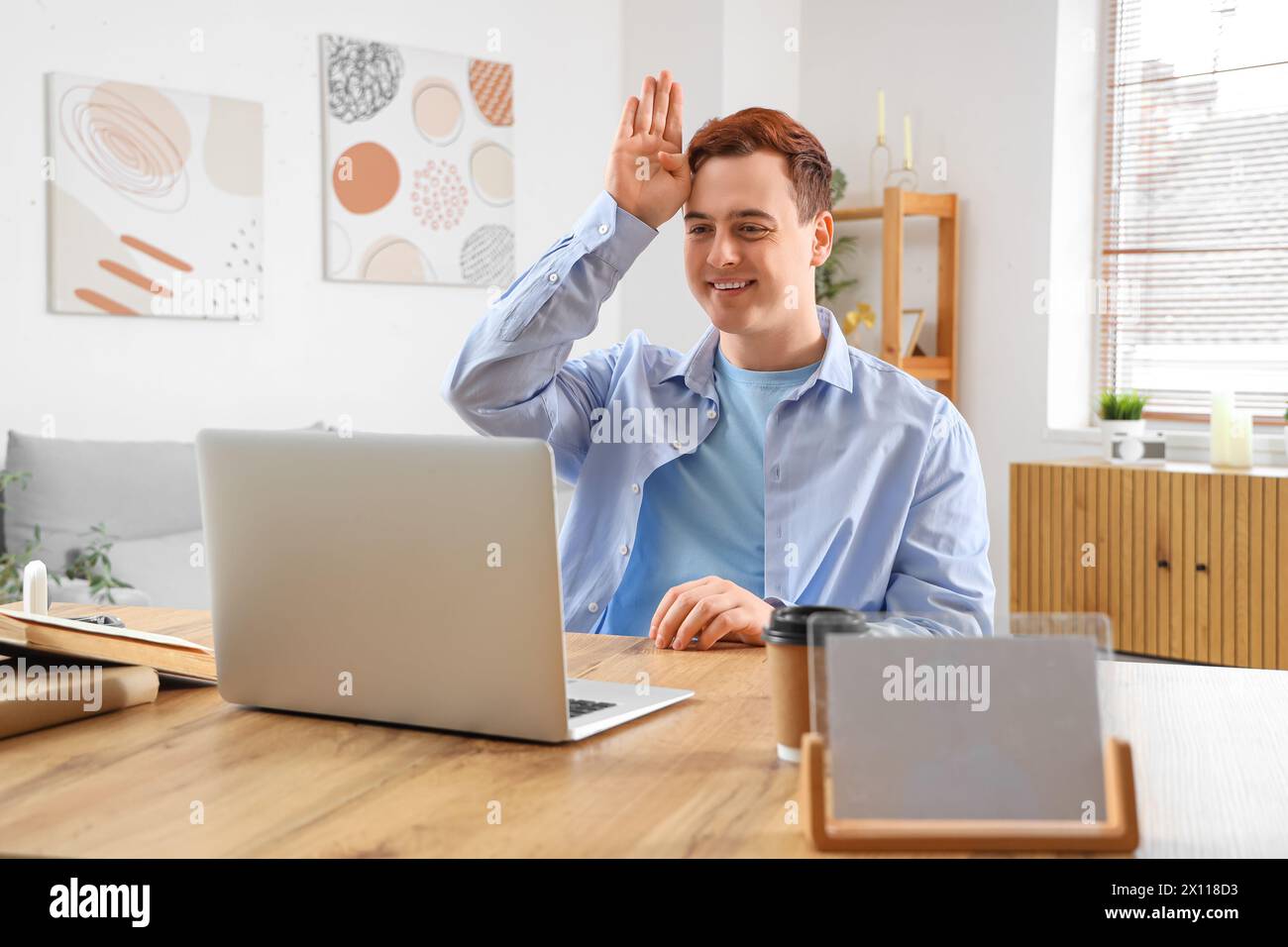 Young deaf mute man video chatting in sign language at home Stock Photo ...