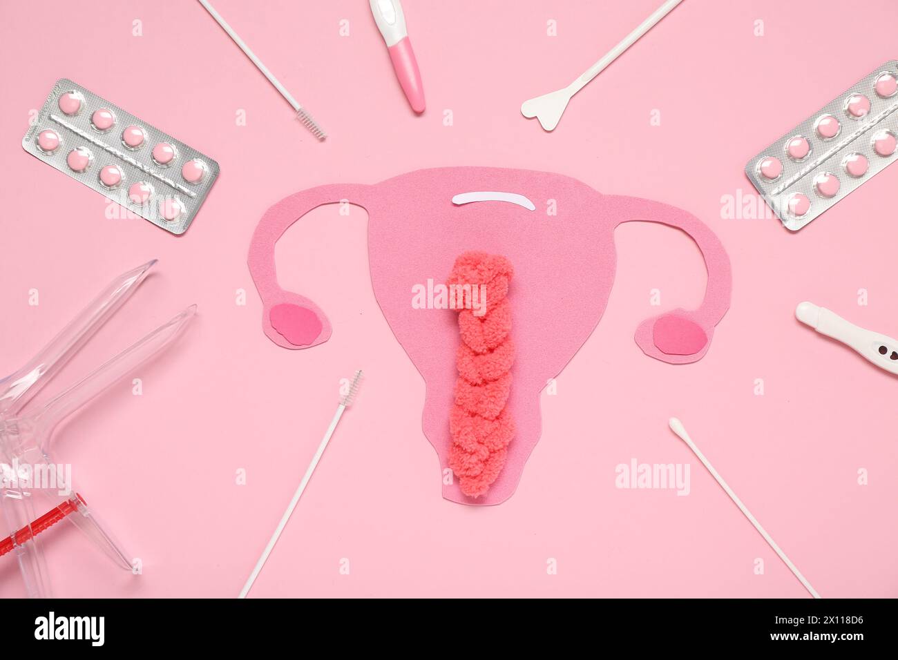 Paper uterus with gynecological speculum, pills and pap smear test ...