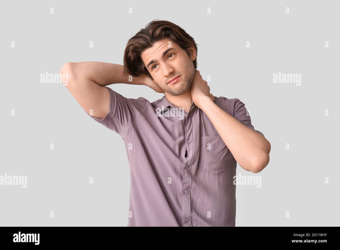 Weary young man on light background Stock Photo - Alamy