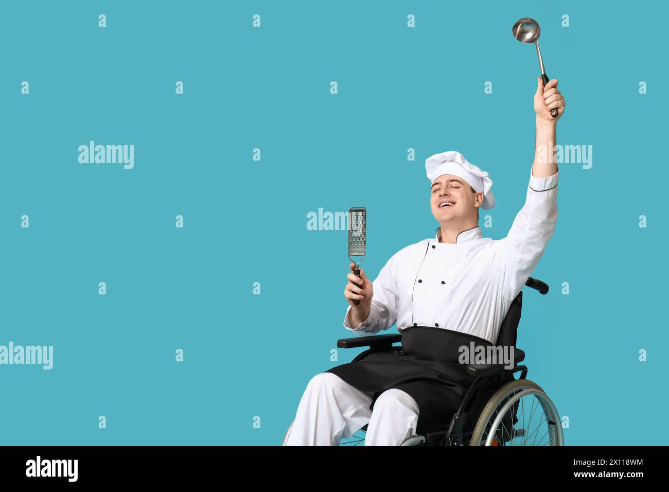 Male chef in wheelchair with kitchen utensils on blue background Stock ...