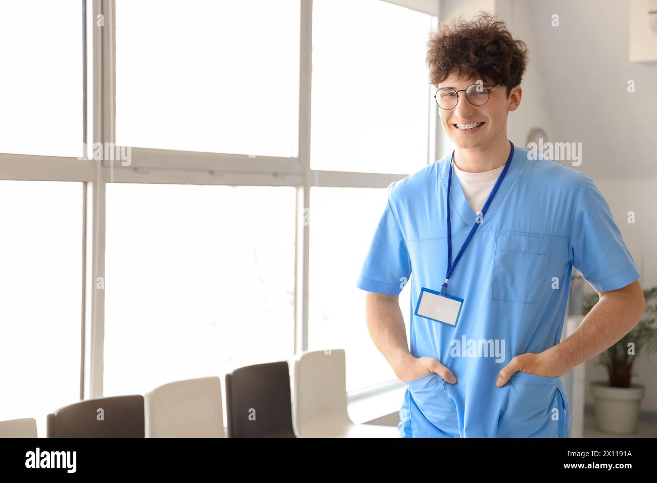Male medical intern smiling in clinic hall Stock Photo - Alamy