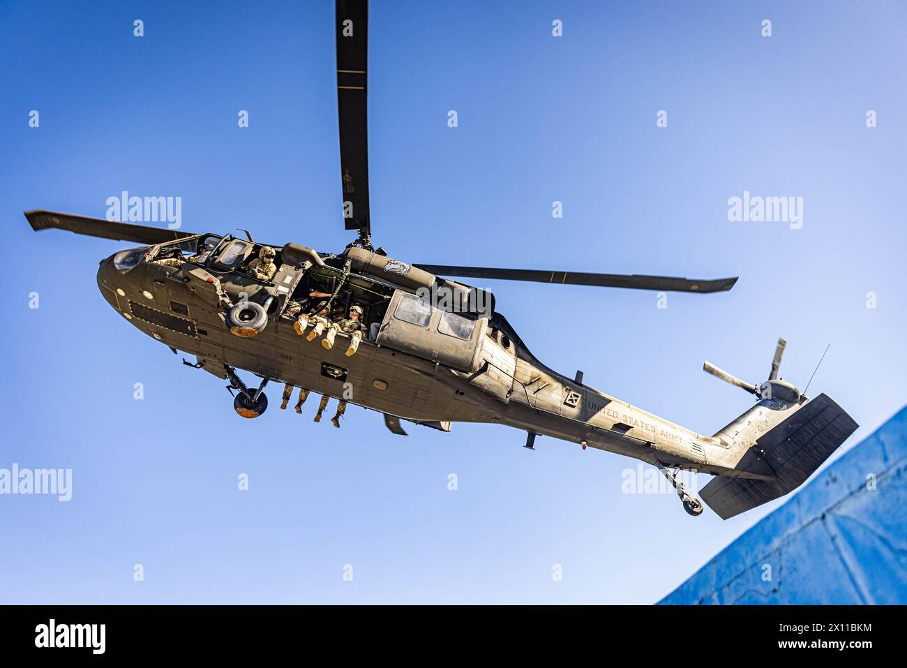 Best Ranger Competition competitors arrive to fast rope from a UH-60 ...