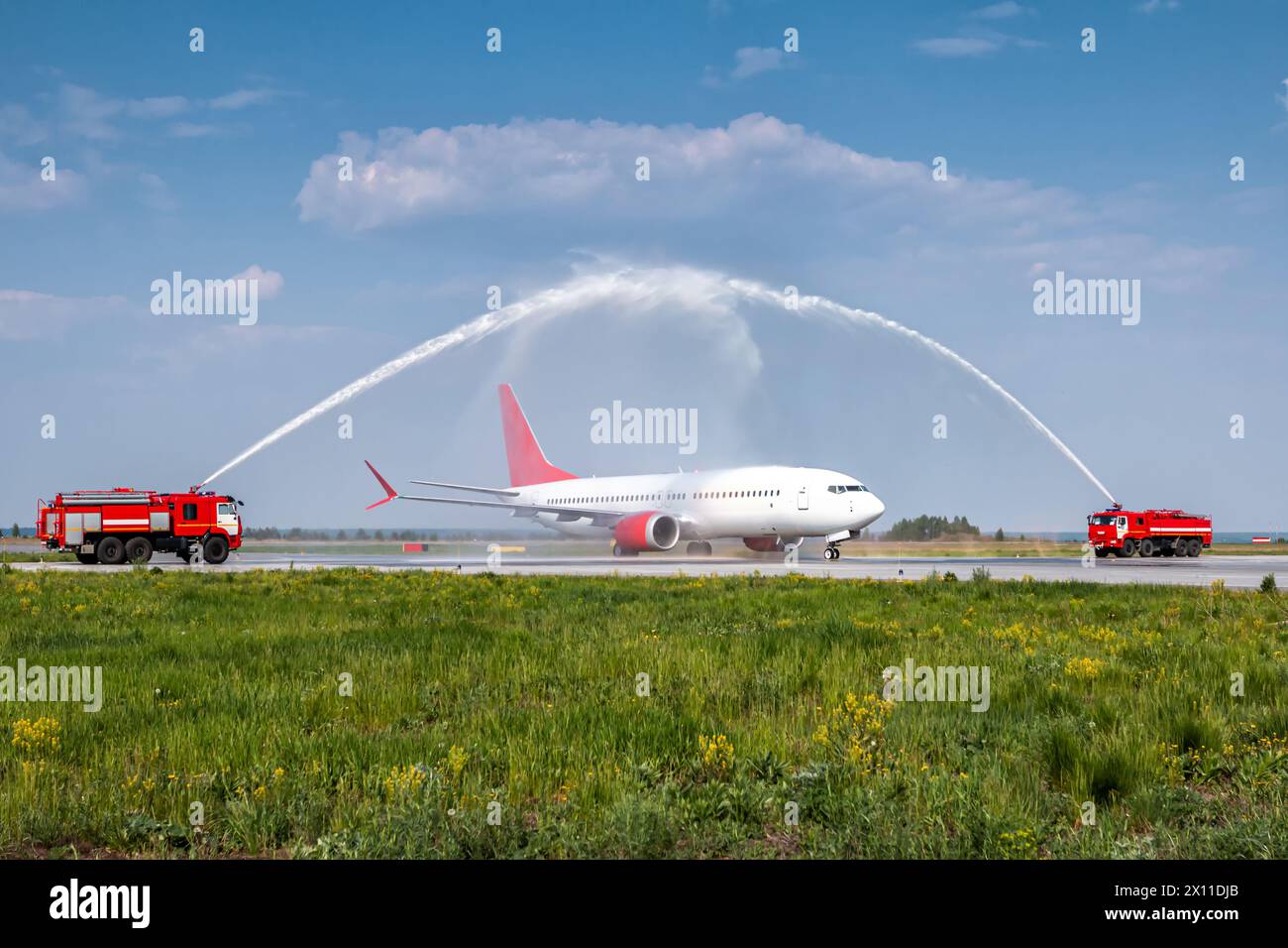 Water arch for first visit white passenger airliner at the airport ...