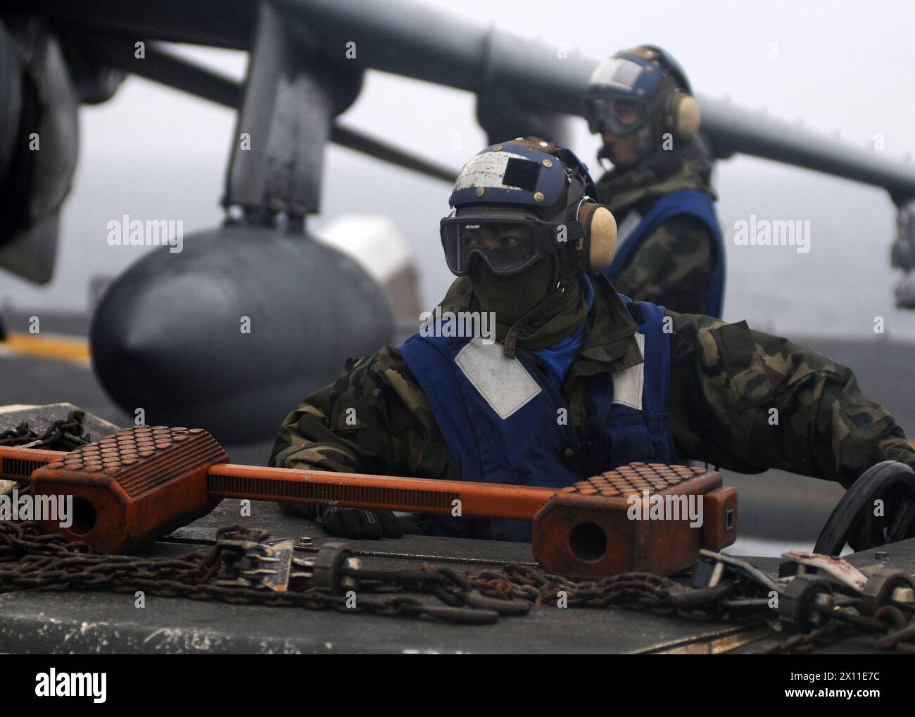 Airman Michael Aranas, aviation boatswain's mate, backs up an aircraft ...