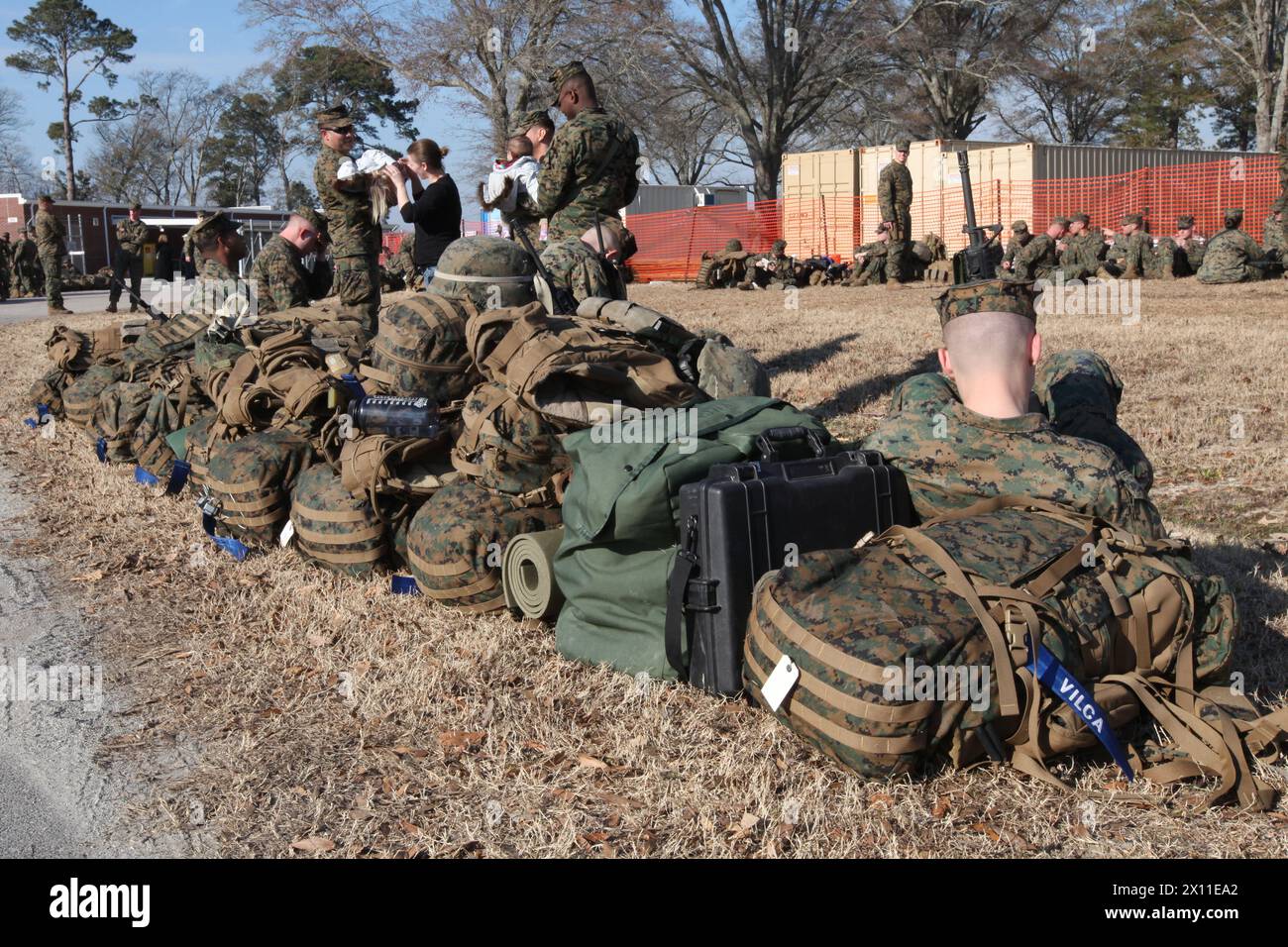 Marines from the 22nd Marine Expeditionary Unit wait to board a buses ...