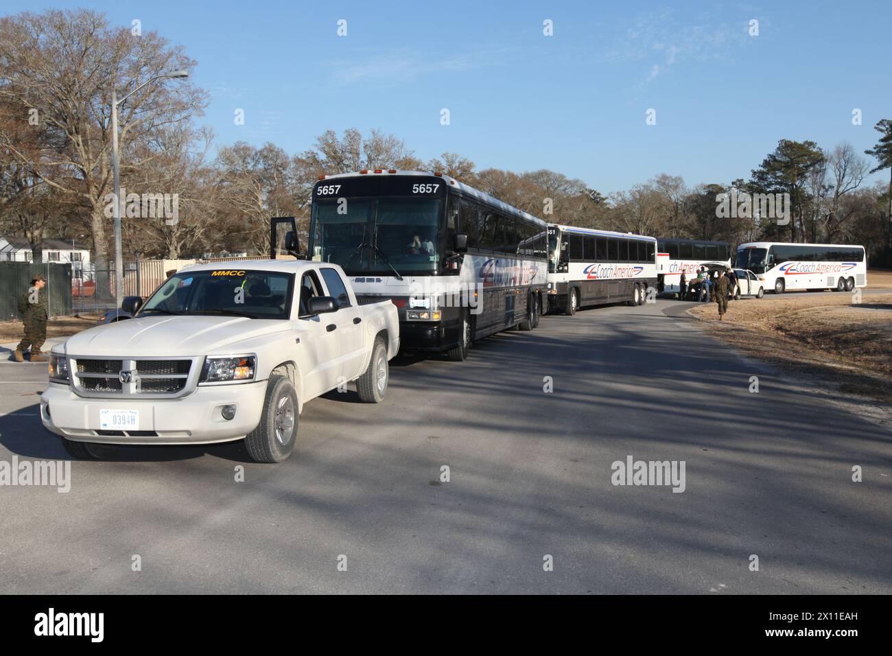 A column of buses carrying members of the 22nd Marine Expeditionary ...