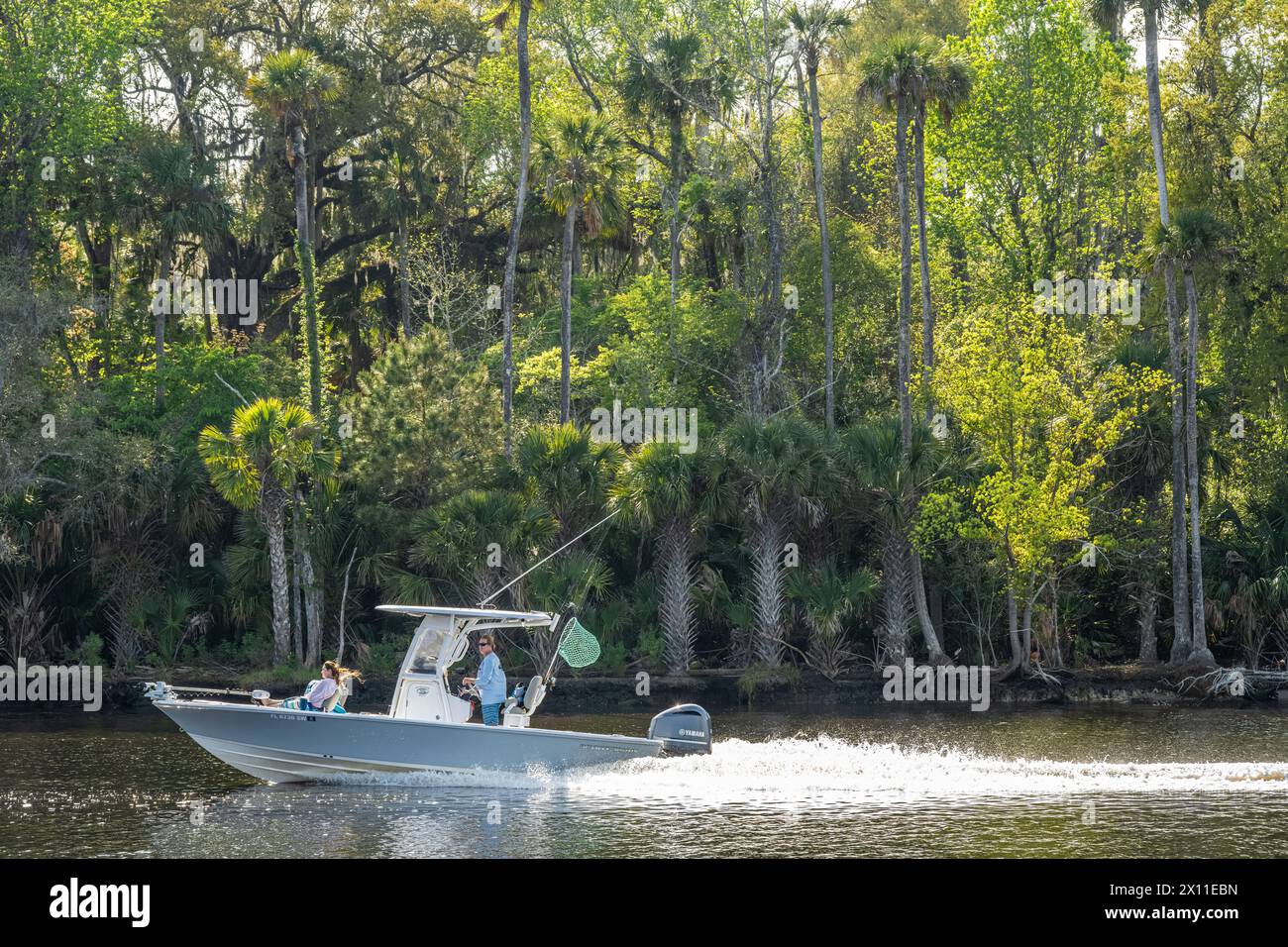 Couple cruising the Intracoastal Waterway in a Sportsman fishing boat ...