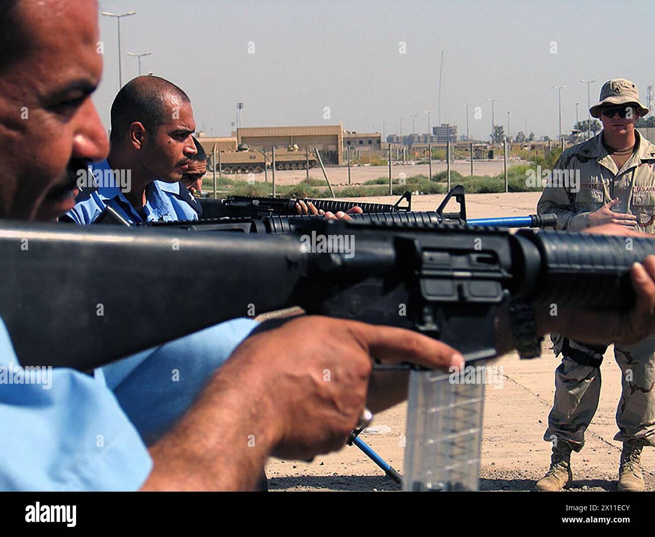 Iraqi Policemen conduct close-quarters fire drills while being coached ...