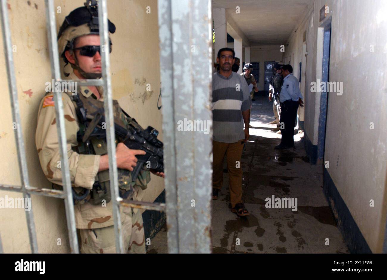 Spc. Stephen Nix guards the entrance to an Iraqi Police station, where ...