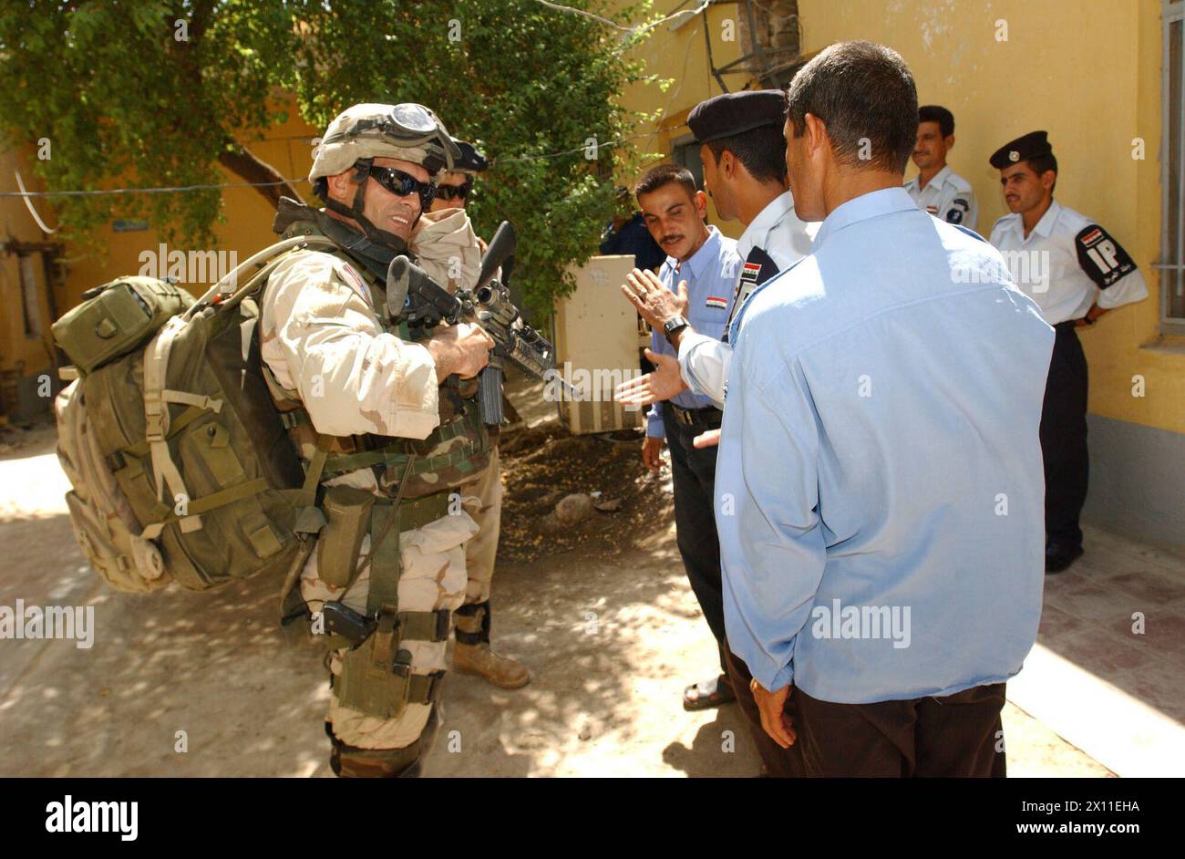 Inside an Al Hayy police station, 1st Lt. John Robinson visits with ...