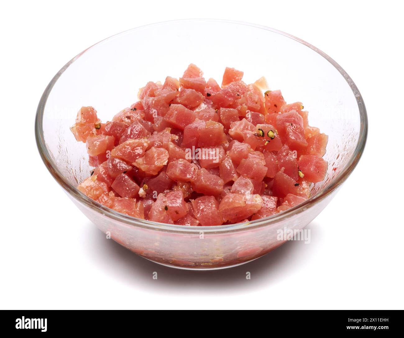 Sliced and chopped tuna fillet in glass bowl isolated on white ...